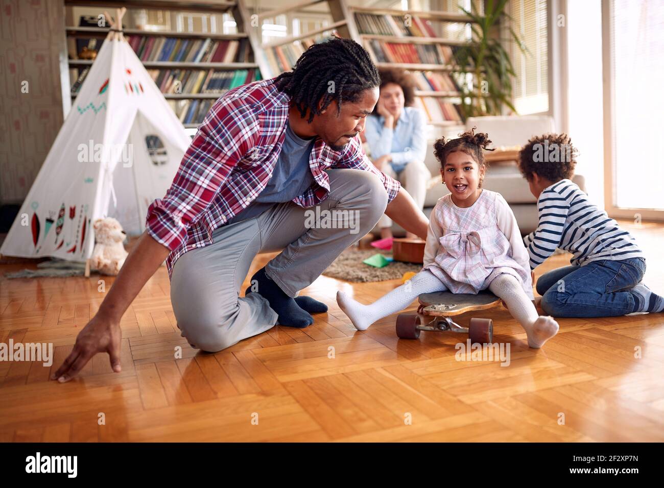 Happy parents enjoy to play with their children in a carefree ...
