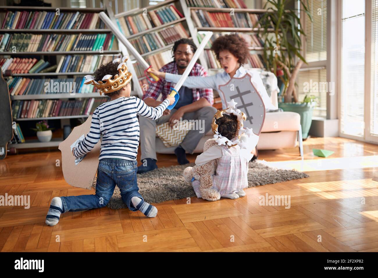Mom and her son playing with swords and enjoying a playtime with family ...