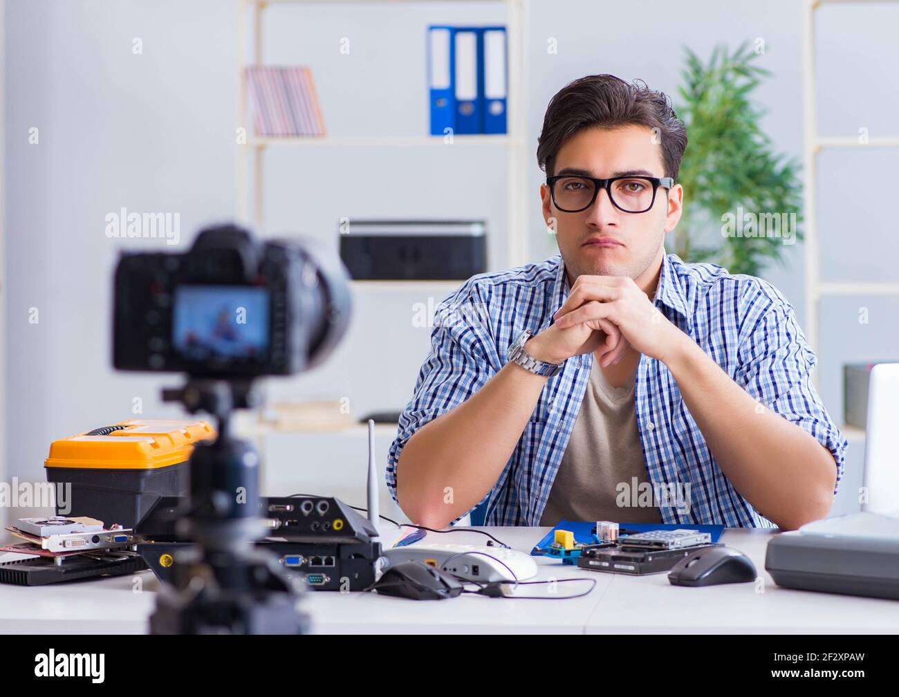 The vlogger recording computer repair on camera for vlog blog Stock ...