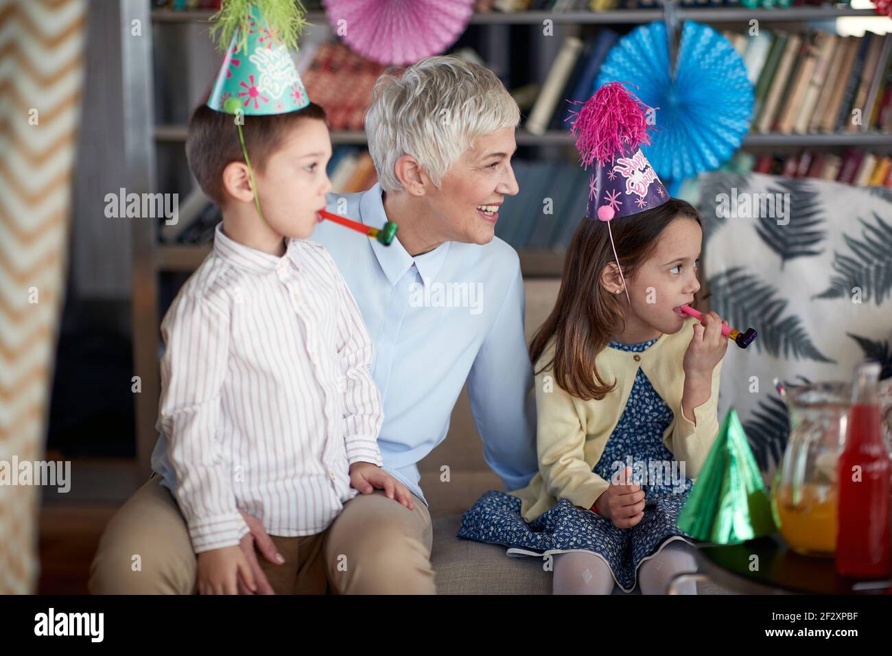 Grandma enjoys a birthday party in a cheerful atmosphere at home with ...