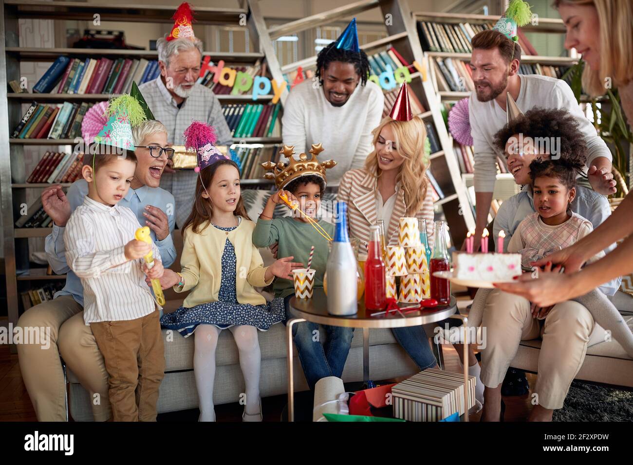 Family generations having a good time at a kids birthday party in a ...