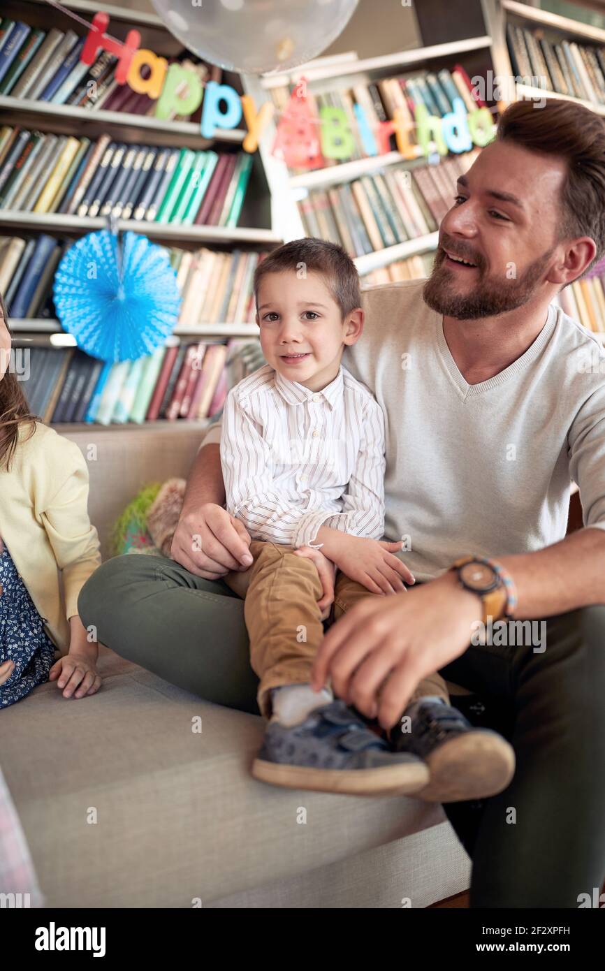 A happy Dad enjoys a kids birthday party in a cheerful atmosphere at ...