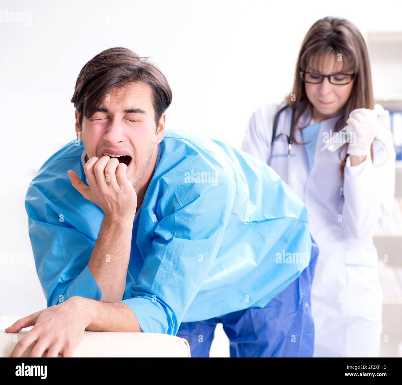 The funny man getting ready for buttocks syringe shot Stock Photo - Alamy