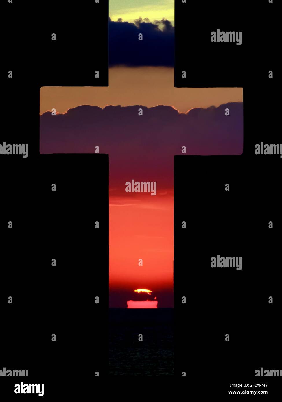 Beautiful colorful sunset through a cross Stock Photo - Alamy