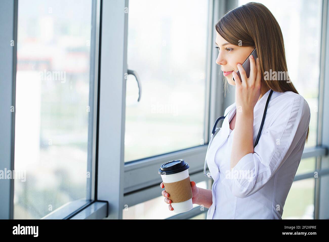 Clinic. Portrait of young doctor standing in medical office Stock Photo ...