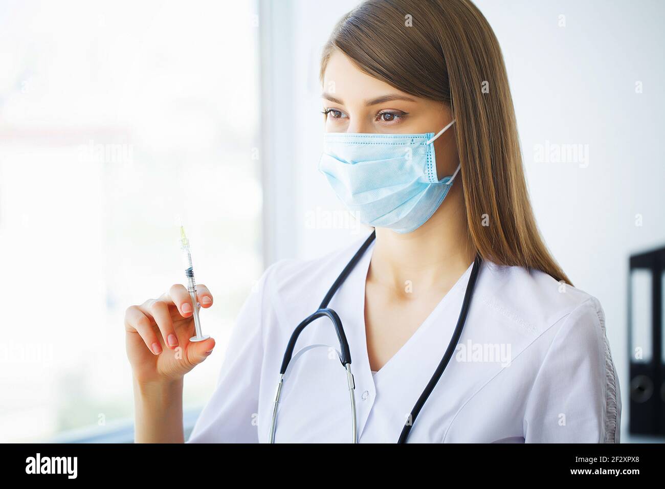 Clinic. Portrait of young doctor standing in medical office Stock Photo ...