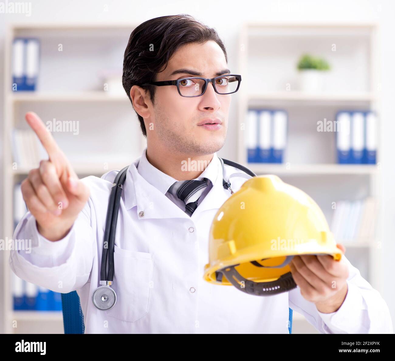 The safety doctor advising about wearing hard hat Stock Photo - Alamy