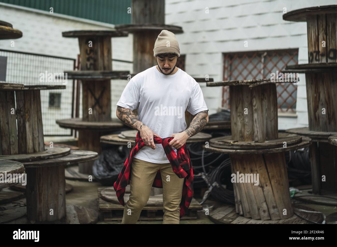 A young Spanish male wearing stylish casual clothes on background of ...