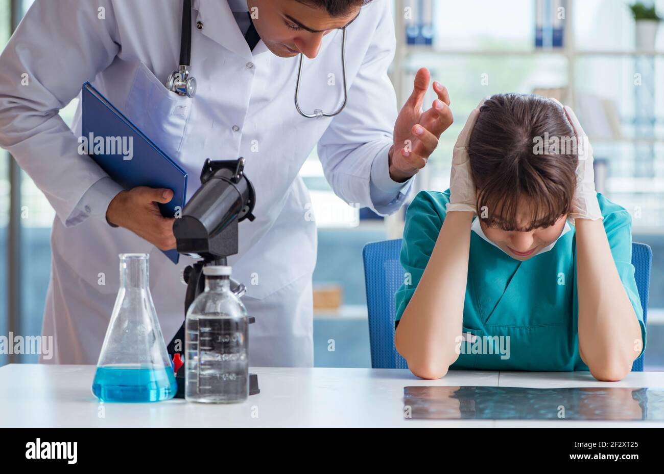The doctor angry at his assistant due to medical error Stock Photo - Alamy