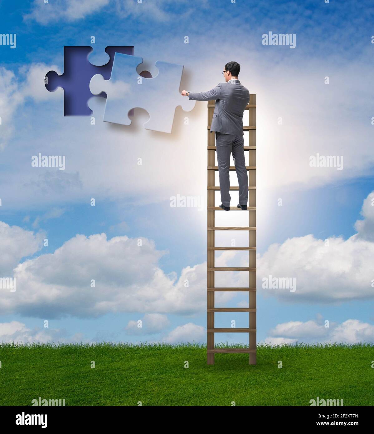 The businessman putting together jigsaw puzzle pieces Stock Photo - Alamy