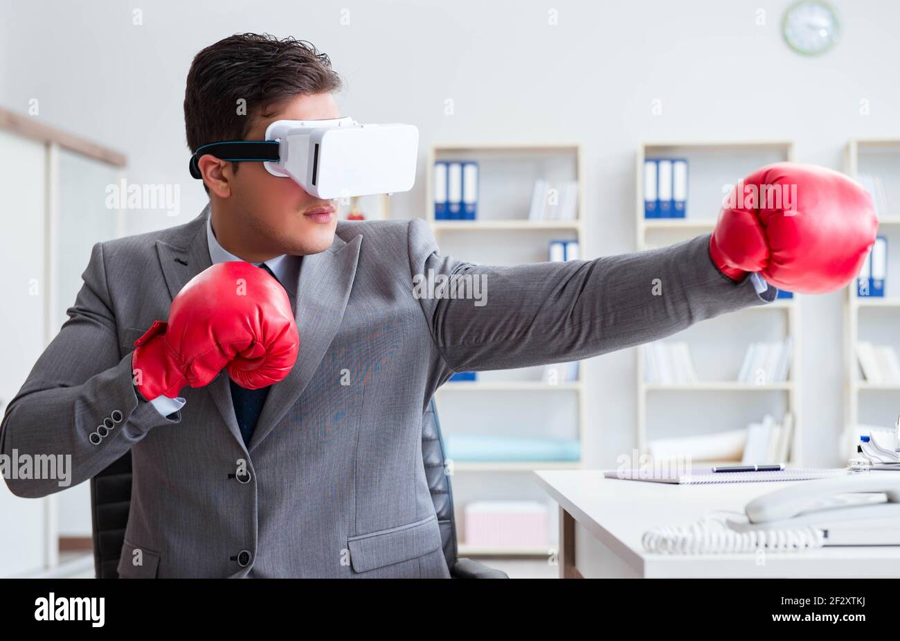 The man boxing in the office with virtual reality goggles Stock Photo ...