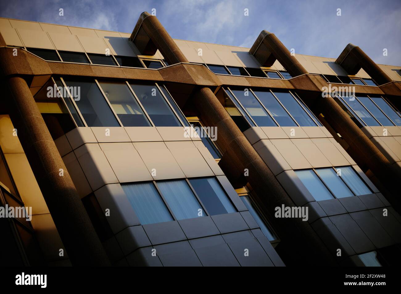 Exterior of 1980s office building with graded high contrast shadowing ...