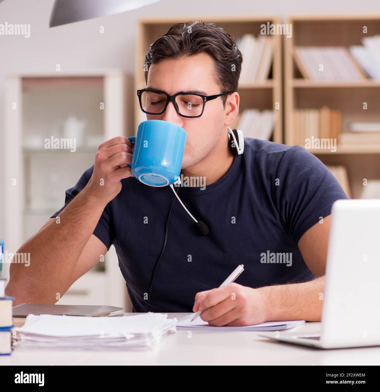 The young student drinking coffee from cup Stock Photo - Alamy