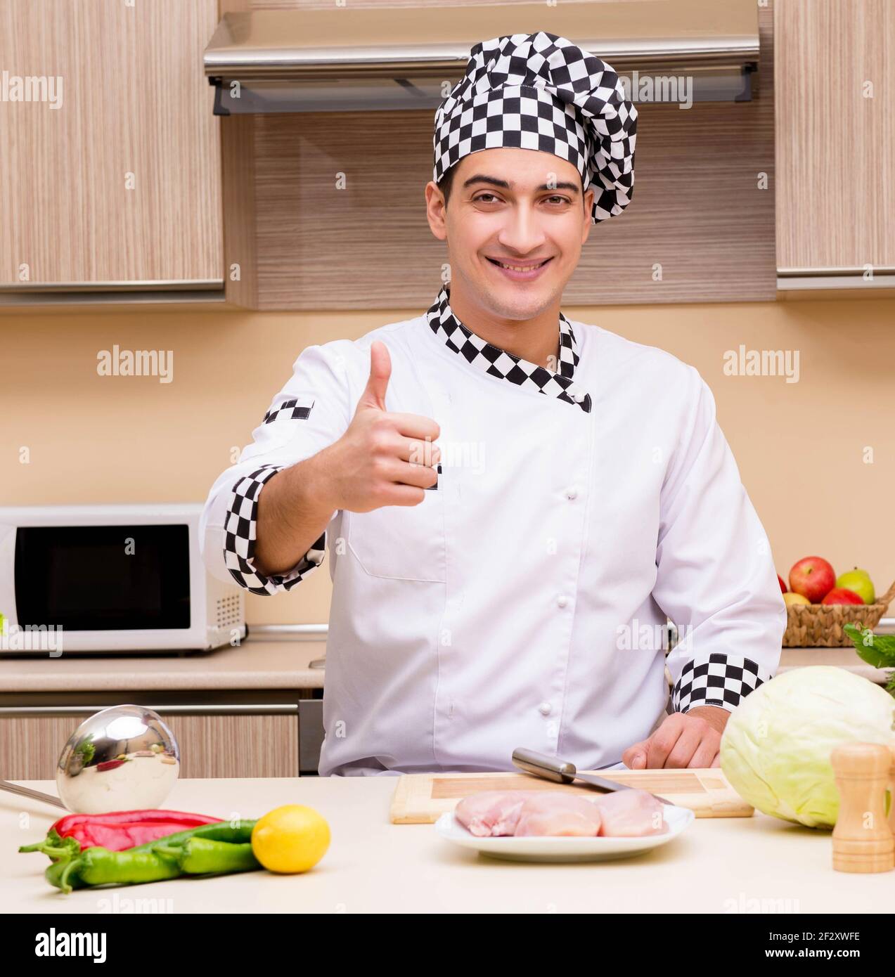 The young chef working in the kitchen Stock Photo - Alamy