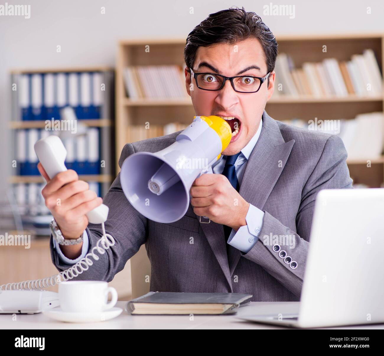 The angry businessman with too much work in office Stock Photo - Alamy