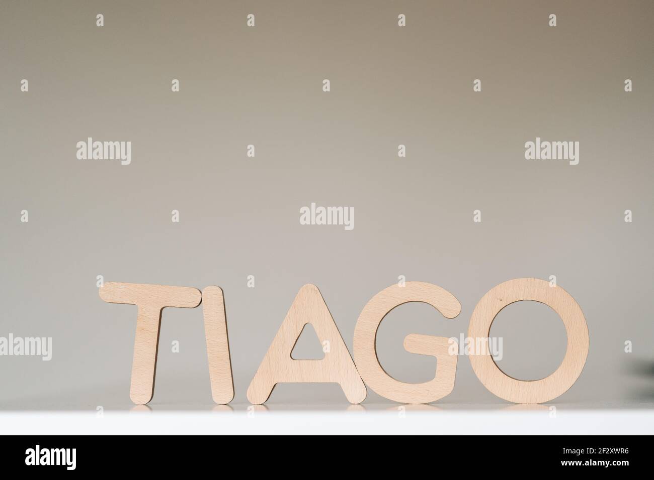 Tiago word made with wooden alphabet letters placed on white table in ...