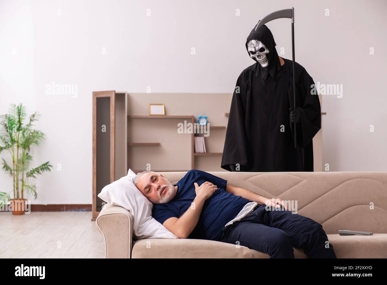 Devil coming to old dying man Stock Photo - Alamy