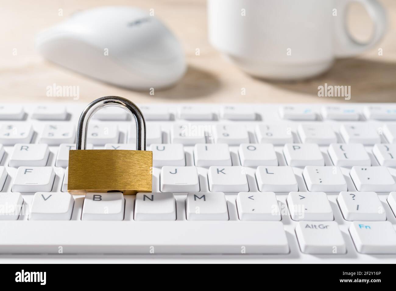 Metal padlock on a white computer keyboard. Closed lock on a desktop keypad. Computer and ...