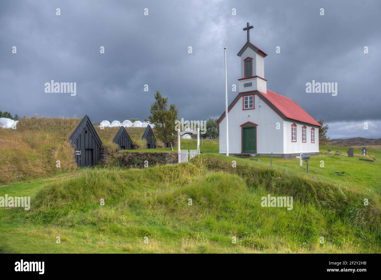 Traditional turf houses and a white church at Keldur at Iceland Stock ...