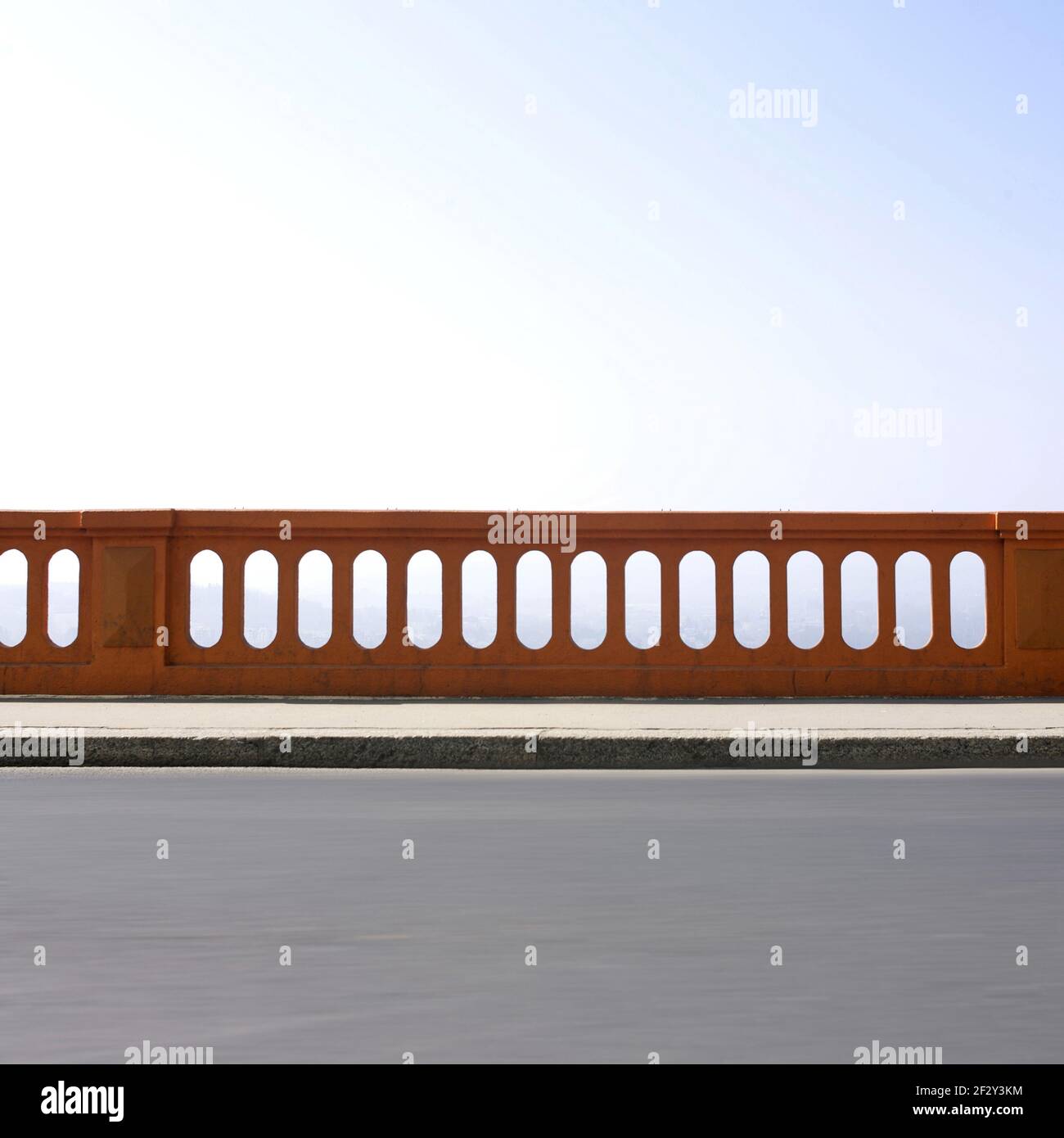 An orange gate near a road with a patterned design Stock Photo - Alamy