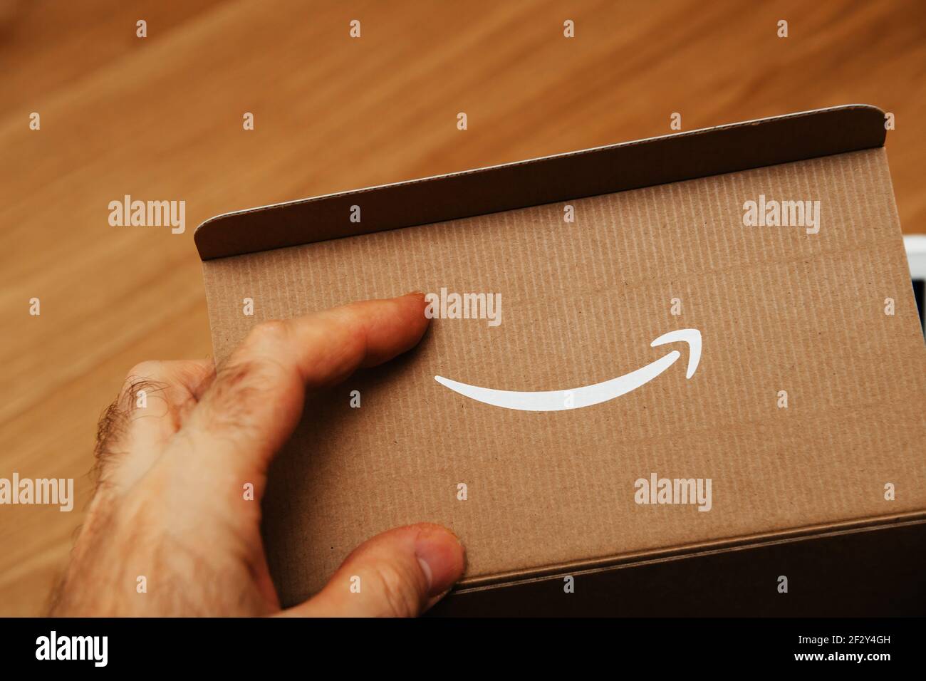 logotype of Amazon Company being cut in the cardboard panel Stock Photo ...