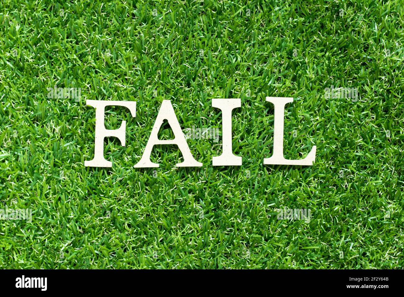 Alphabet letter in word fail on green grass background Stock Photo - Alamy