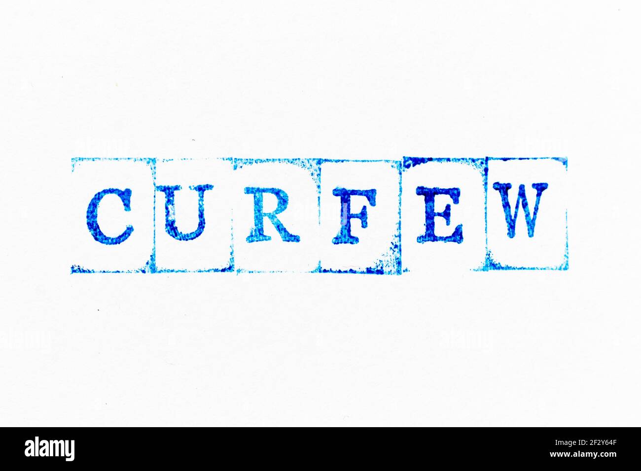 Blue color ink rubber stamp in word curfew on white paper background ...