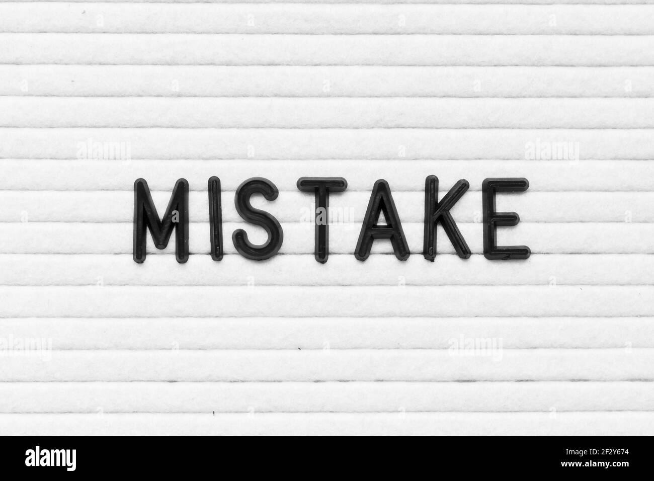 Black color letter in word mistake on white felt board background Stock ...