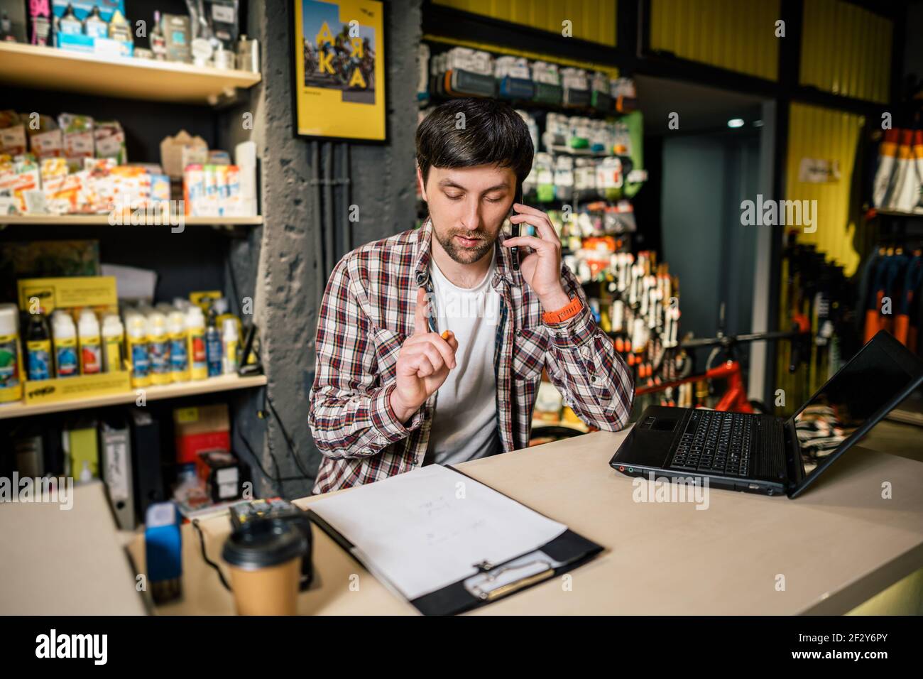 Man takes order by phone in his sporting goods store for sports and ...