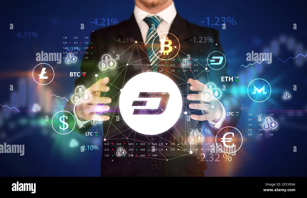 Businessman holding currency symbols Stock Photo - Alamy