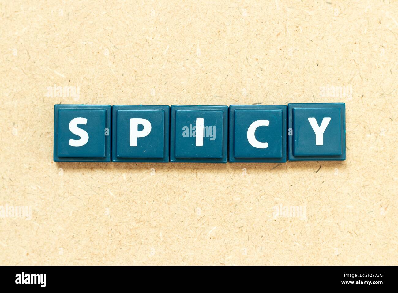 Tile alphabet letter in word spicy on wood background Stock Photo - Alamy