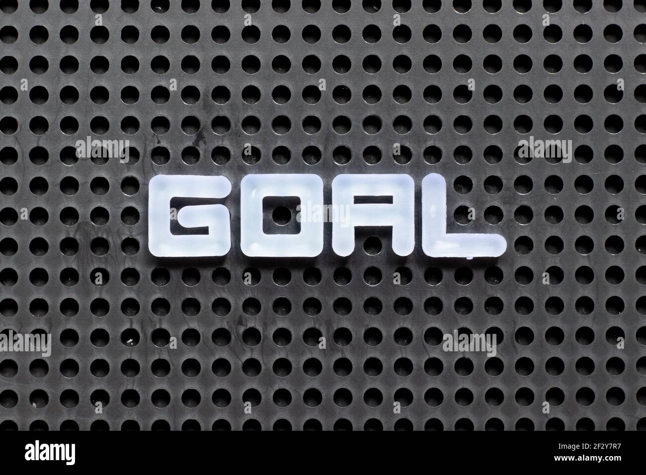 White color letter in word goal on black pegboard background Stock ...