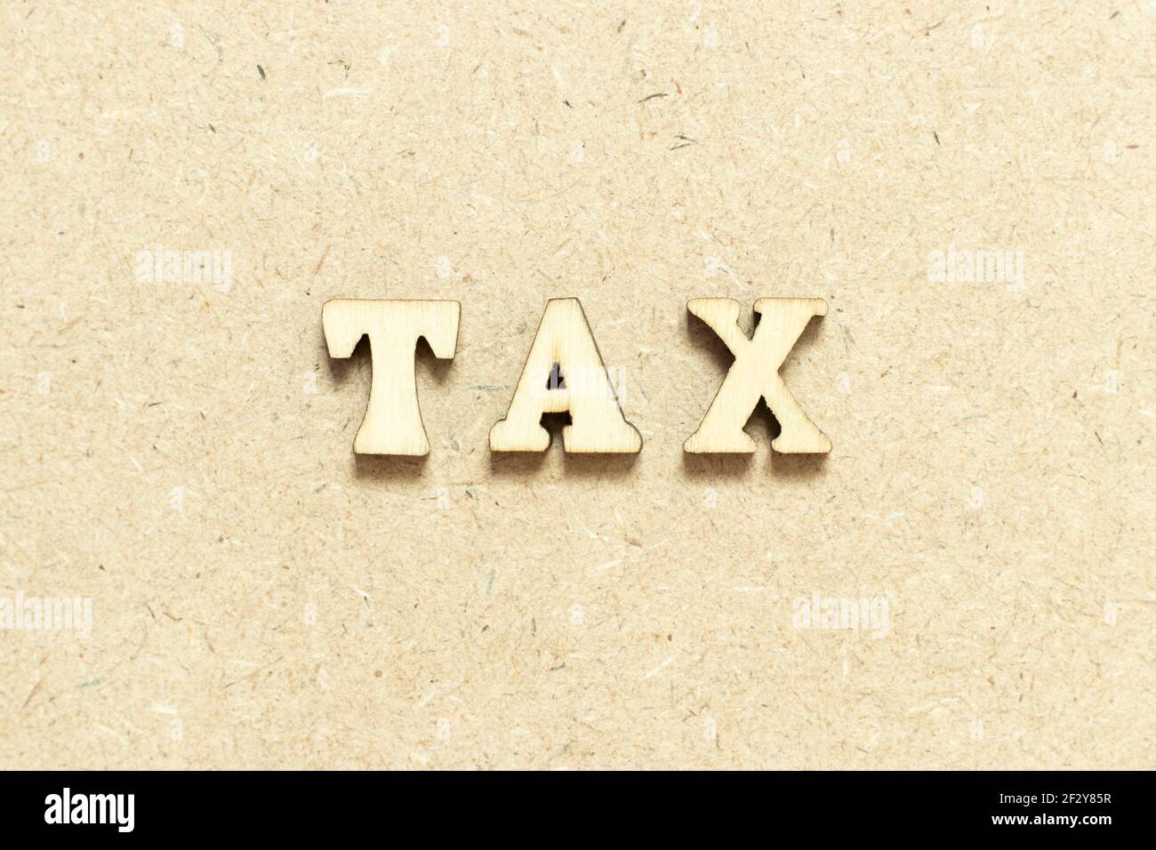 Alphabet letter in word tax on wood background Stock Photo - Alamy