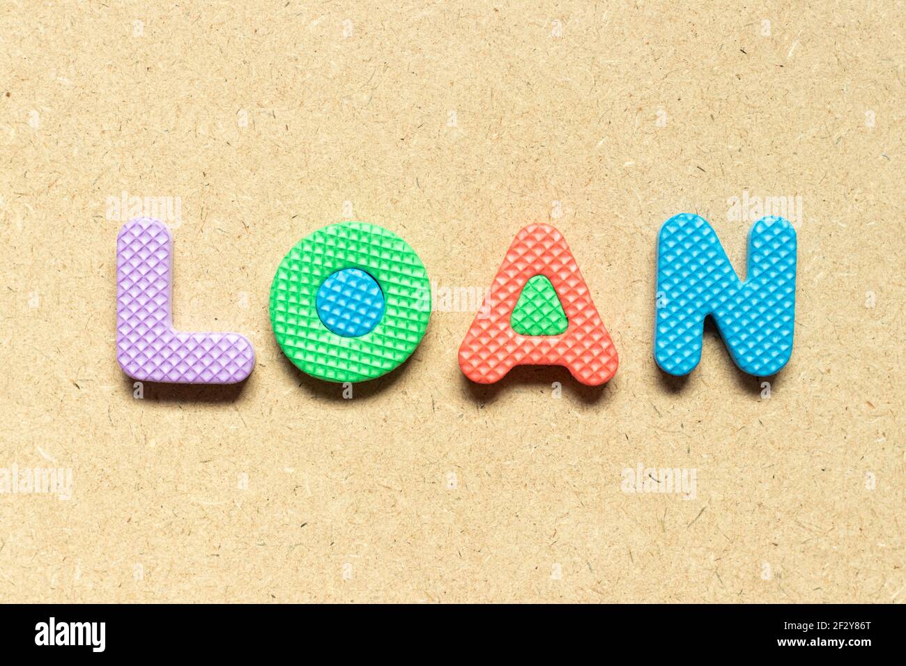 Foam alphabet letter in word loan on wood background Stock Photo - Alamy