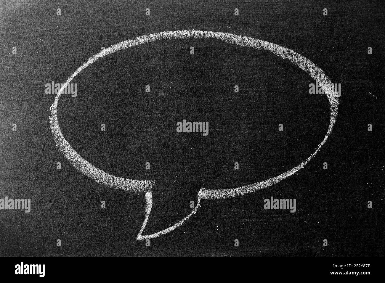 White color chalk hand drawing in round bubble speech shape with blank ...