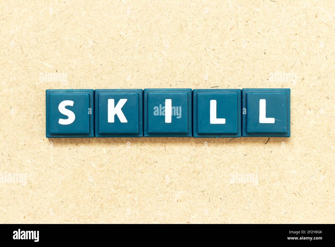 Tile alphabet letter in word skill on wood background Stock Photo - Alamy