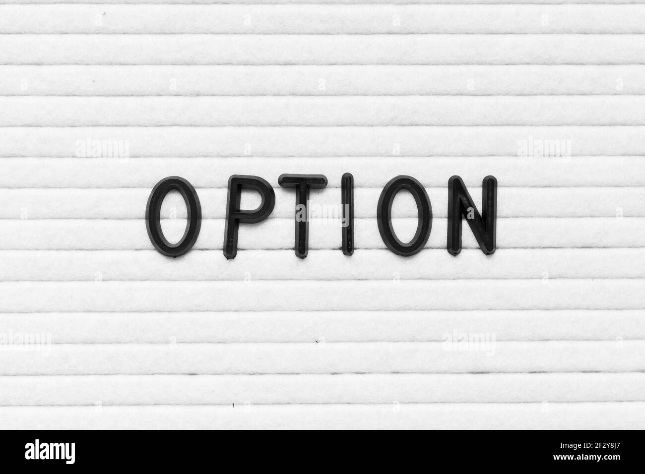 Black color letter in word option on white felt board background Stock ...