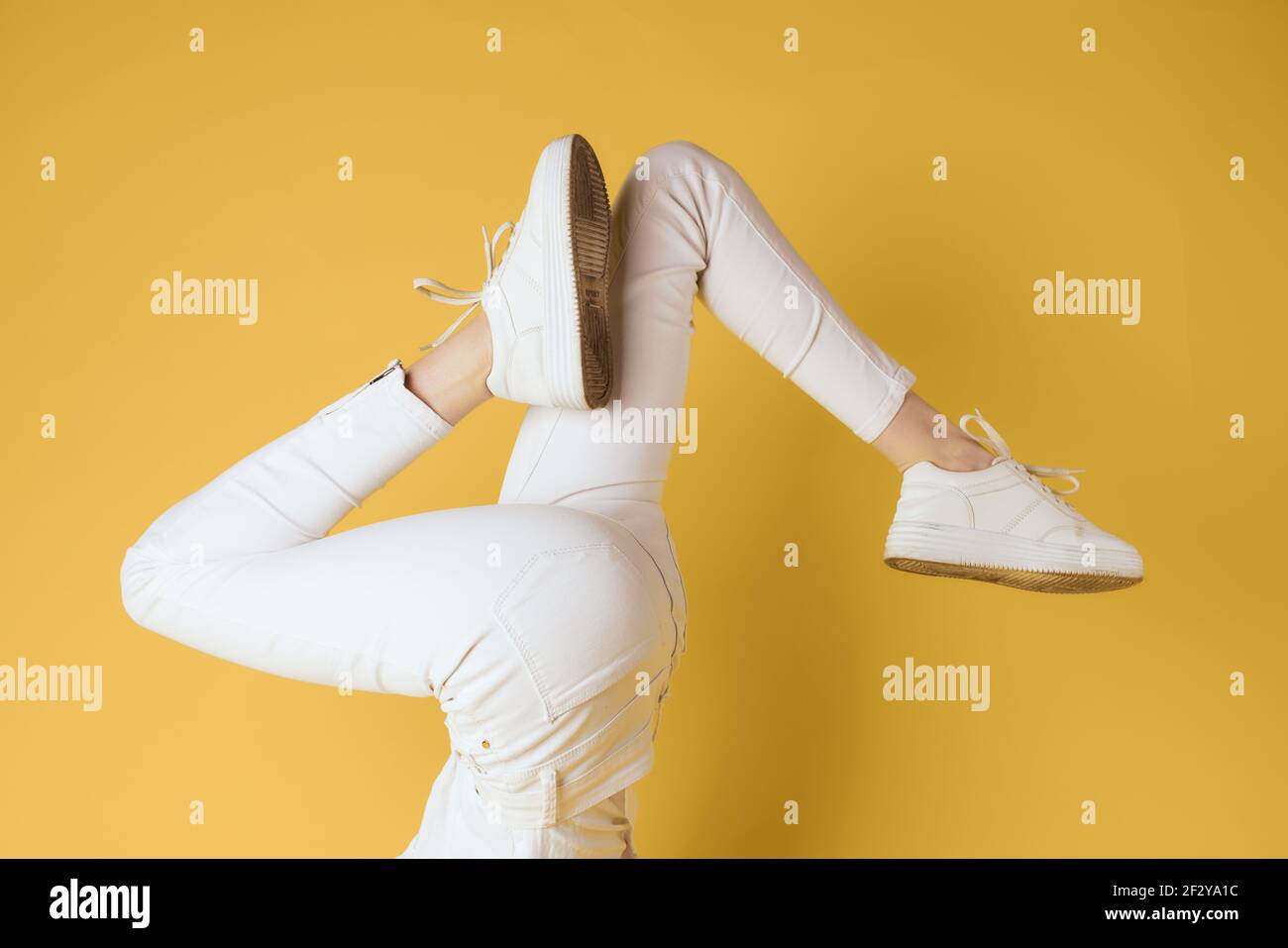 Inverted womens legs sneakers fashion studio street style Stock Photo ...