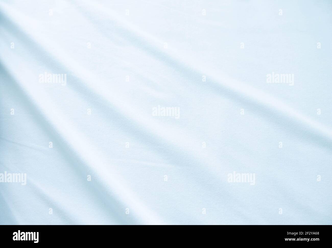 Fabric texture with light waves. Slightly wrinkled fabric. A sheet of ...