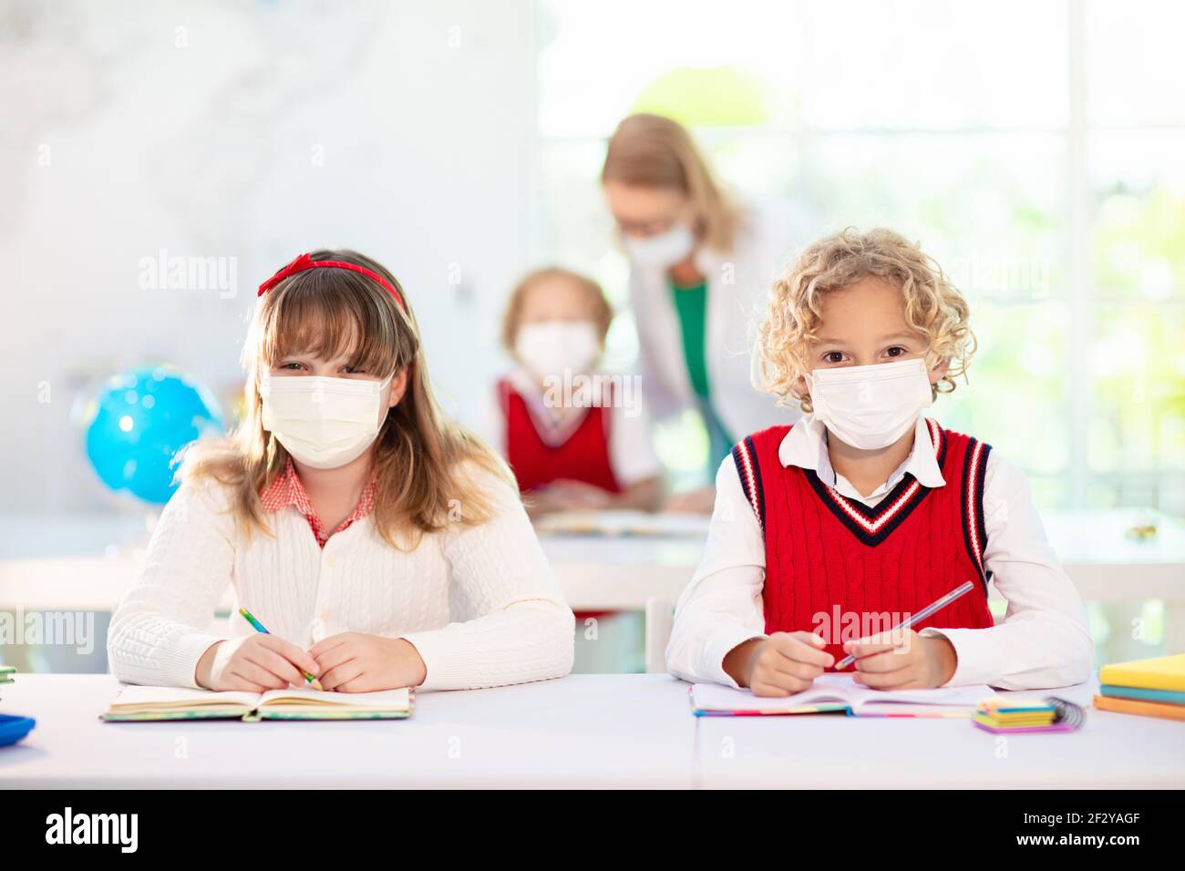 Kids in face mask in school class. Child back to school after ...