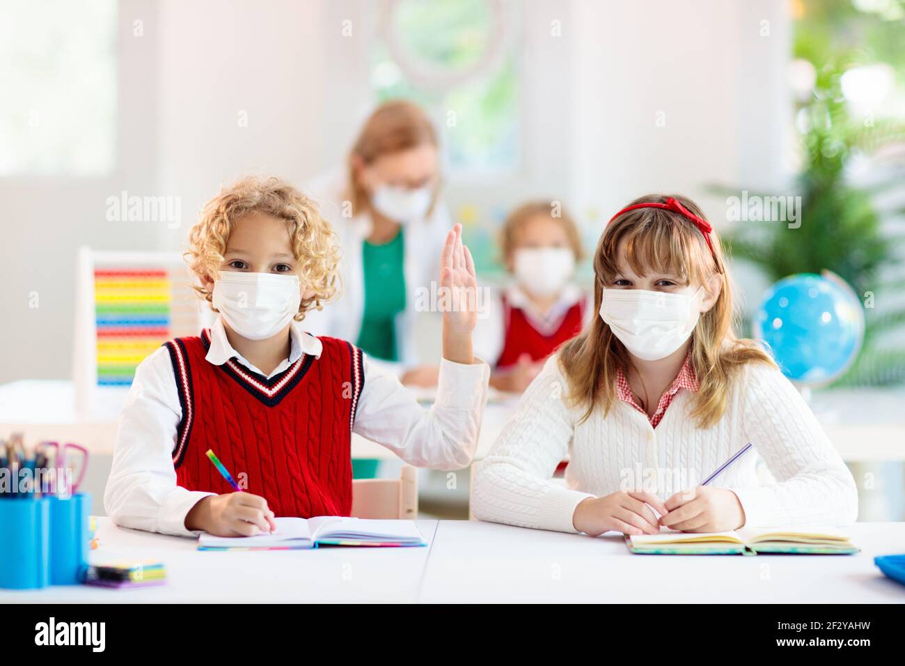 Kids in face mask in school class. Child back to school after ...