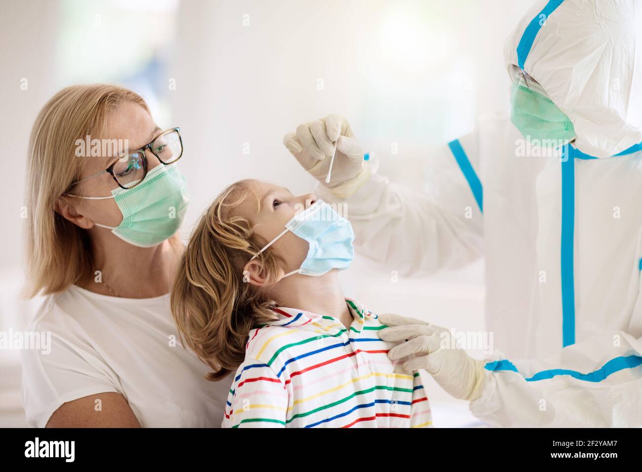 Coronavirus nasal swab test for kids. Doctor taking saliva sample for ...