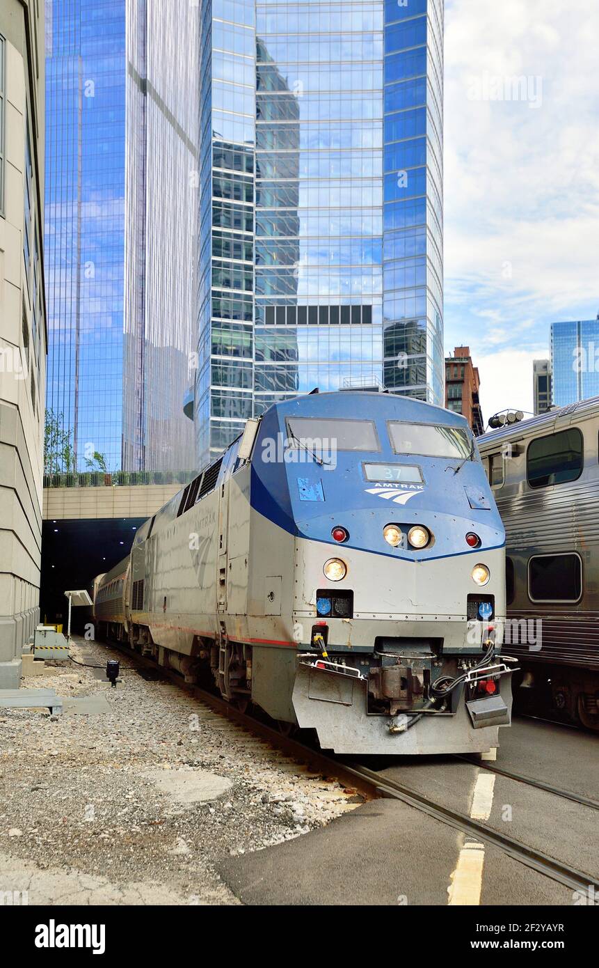 Chicago, Illinois, USA. An outbound Amtrak passenger train emerges from ...