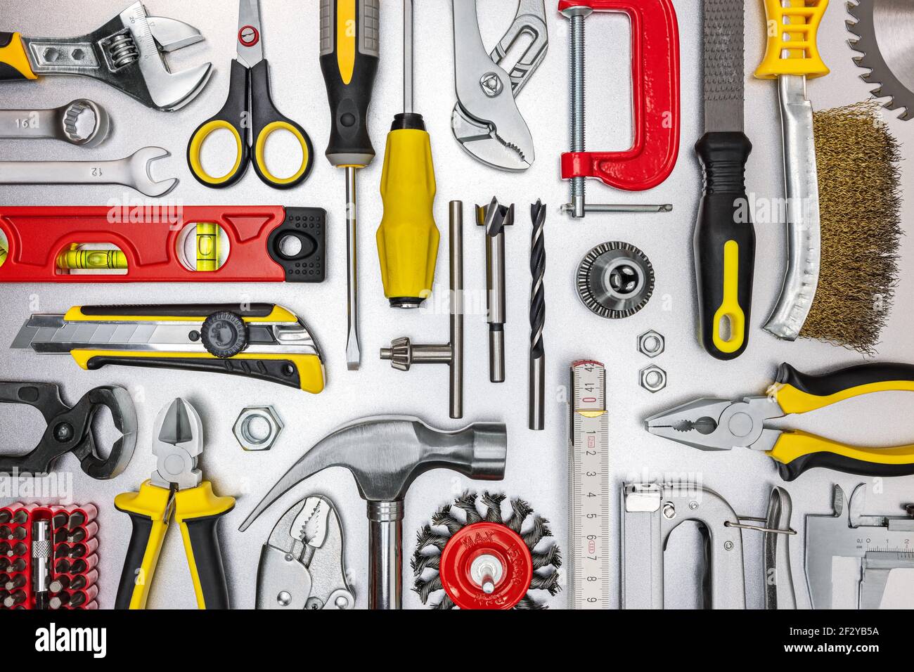 different kinds of work tools on grey metal background. view from above ...