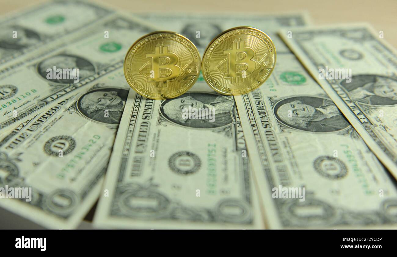 SHIYAN, CHINA - MARCH 13, 2021 - Bitcoins and US dollars, Shiyan, Hubei ...