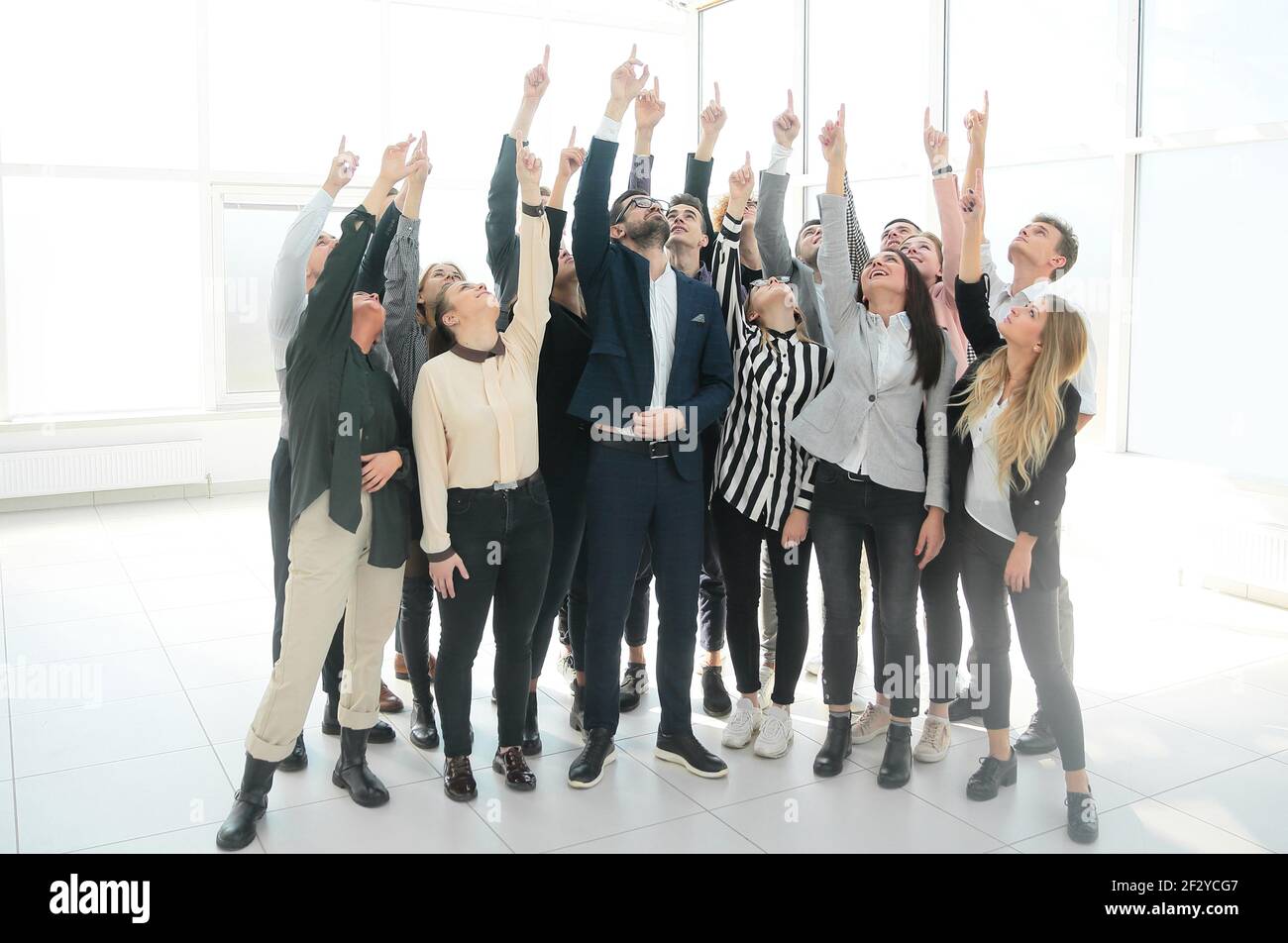 group of diverse young people pointing up Stock Photo - Alamy