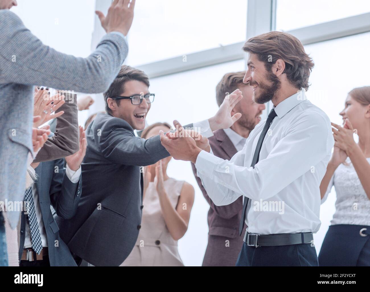 corporate group of employees congratulating each other on the victory ...