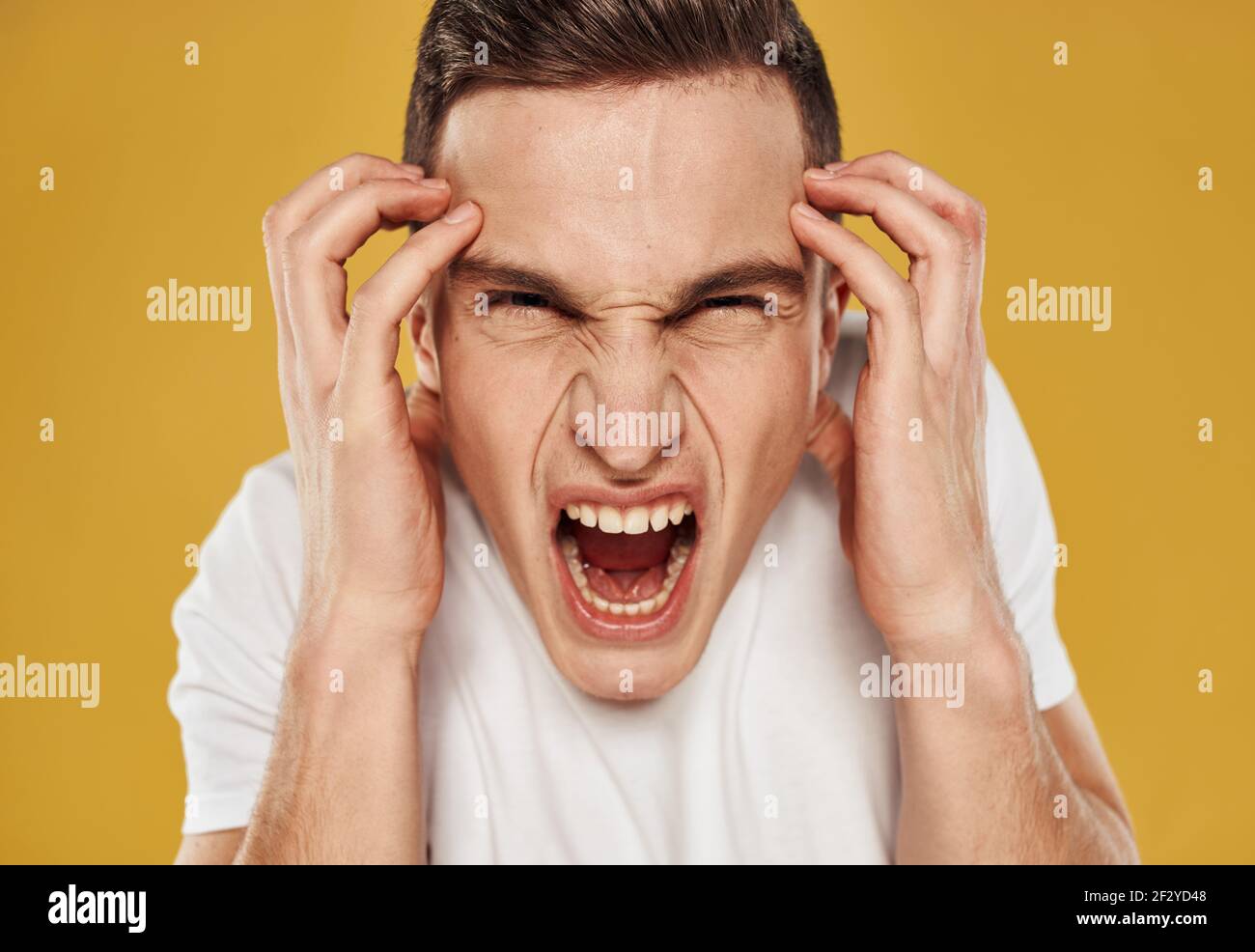 Aggressive man touches his head emotions model irritability Stock Photo ...
