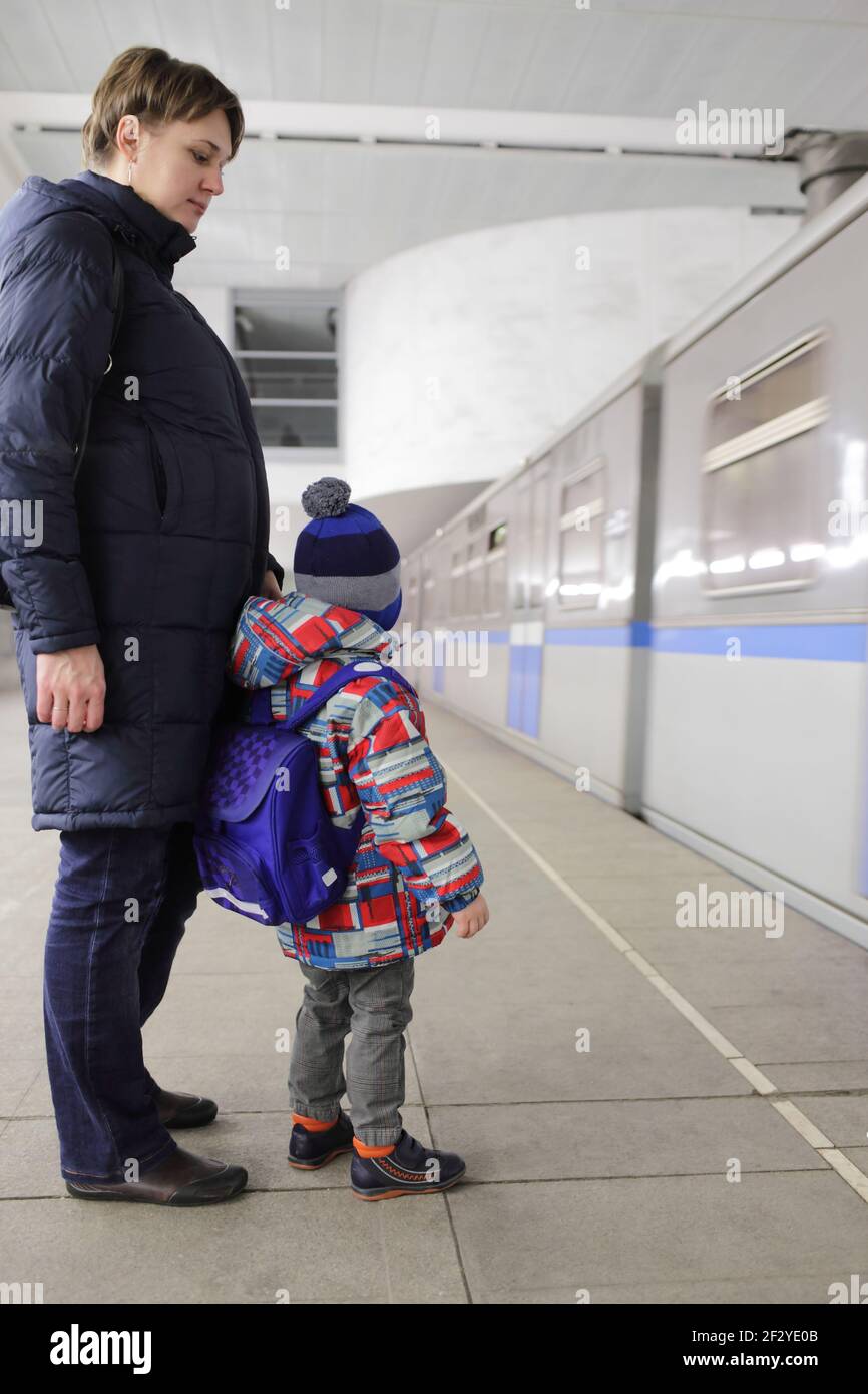 Mother with her son waiting train on subway platform Stock Photo - Alamy