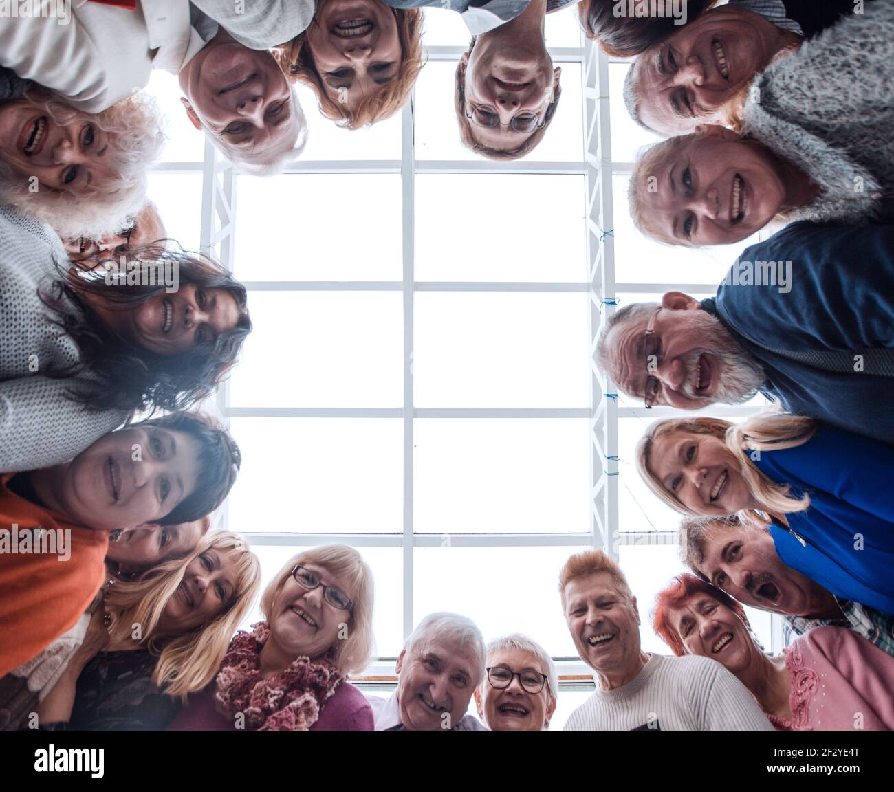 Happy people looking down at camera Stock Photo - Alamy